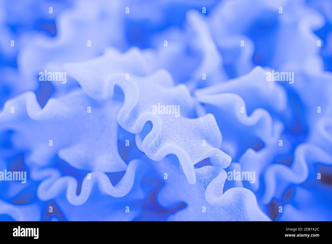 Italian dry wavy pasta background in blue abstract color. Healthy ...