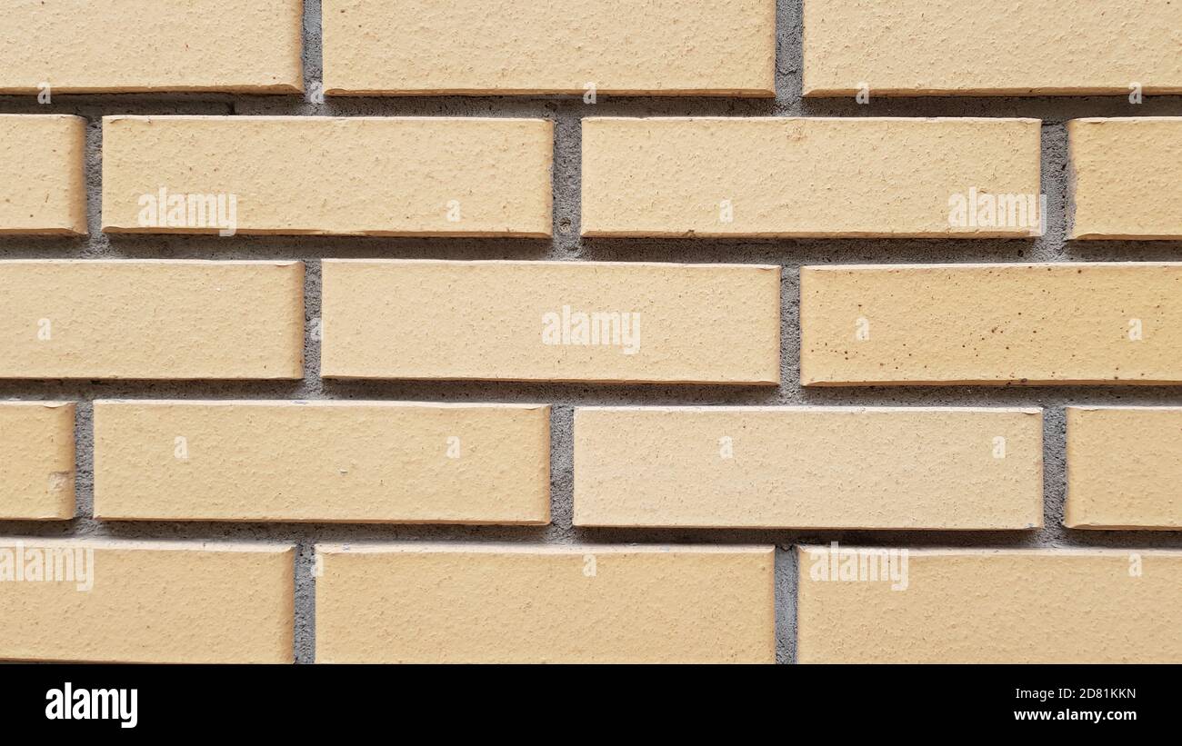 Straight rectangular brick textured background. Beige color brickwork ...