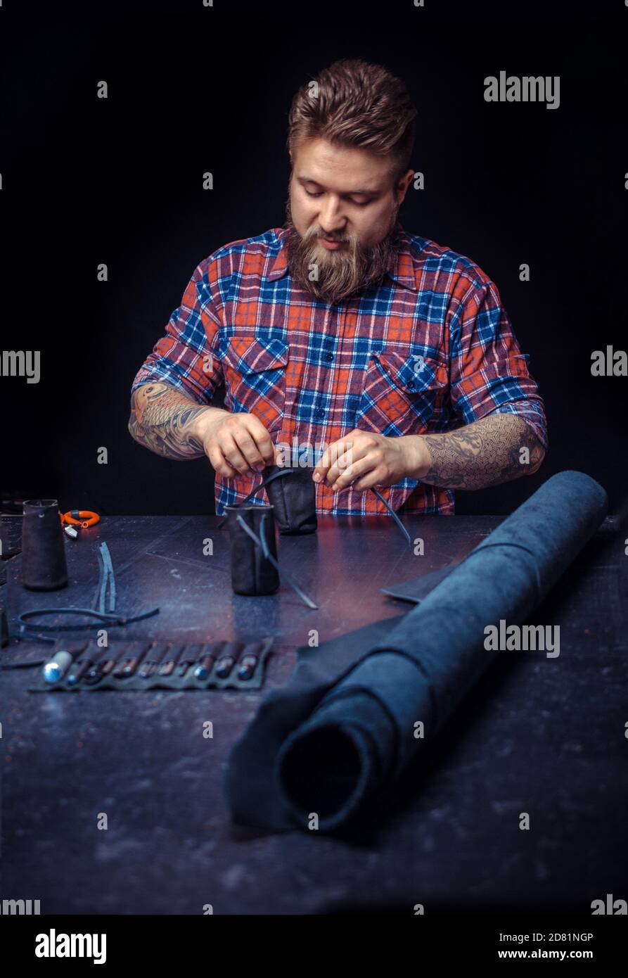 Leather Craftsman demonstrates leather cutting process Stock Photo - Alamy