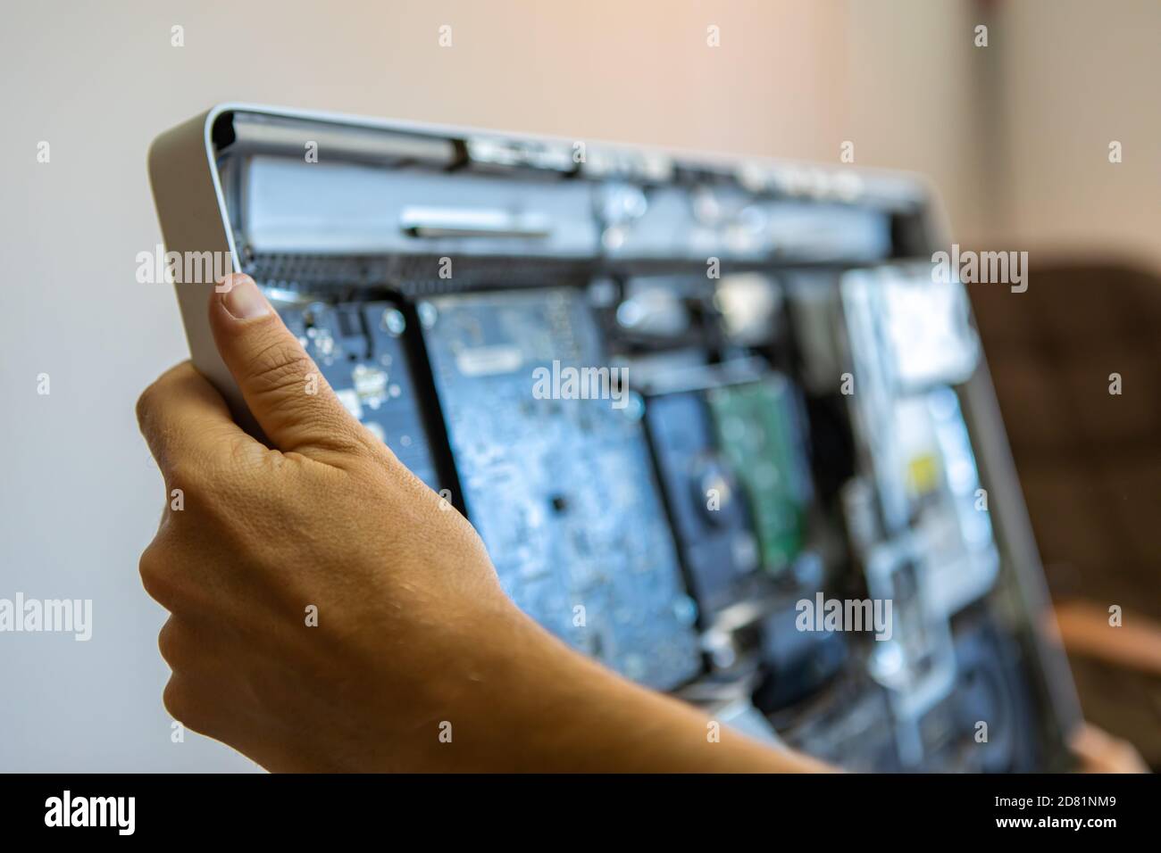 Selective focus of hands of young male computer engineer holding fancy ...
