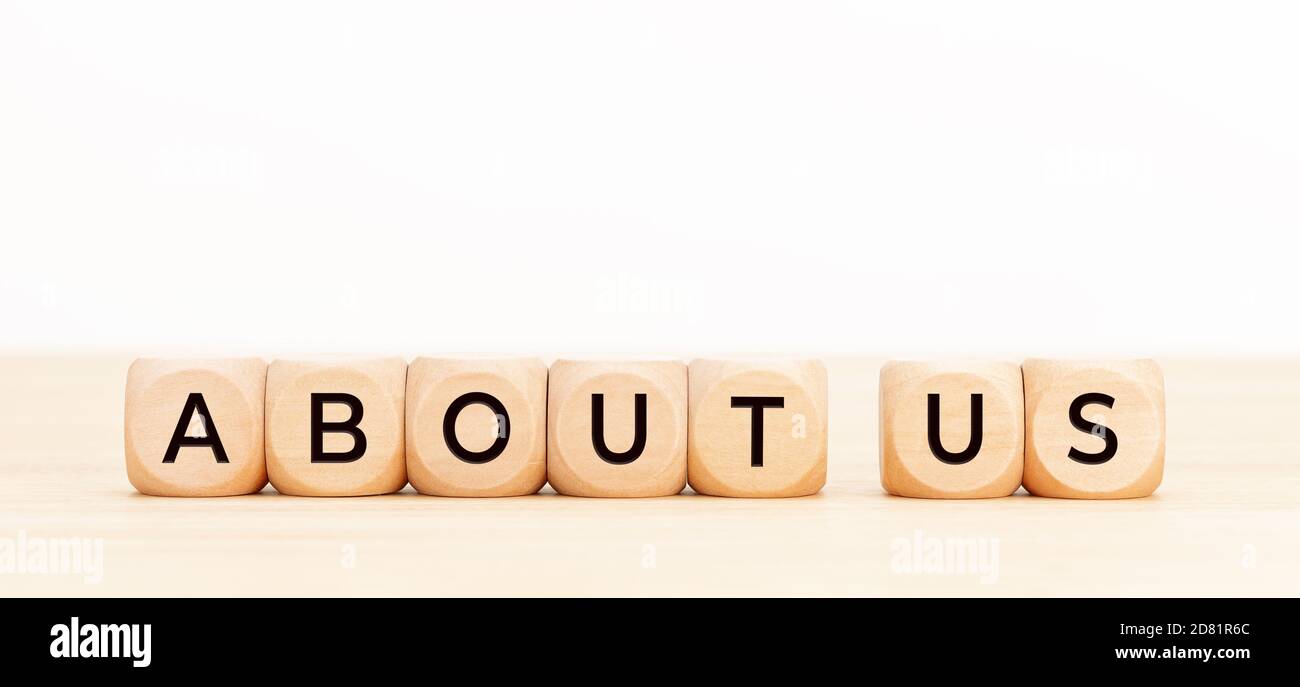 Wooden block with message about us. Copy space Stock Photo - Alamy