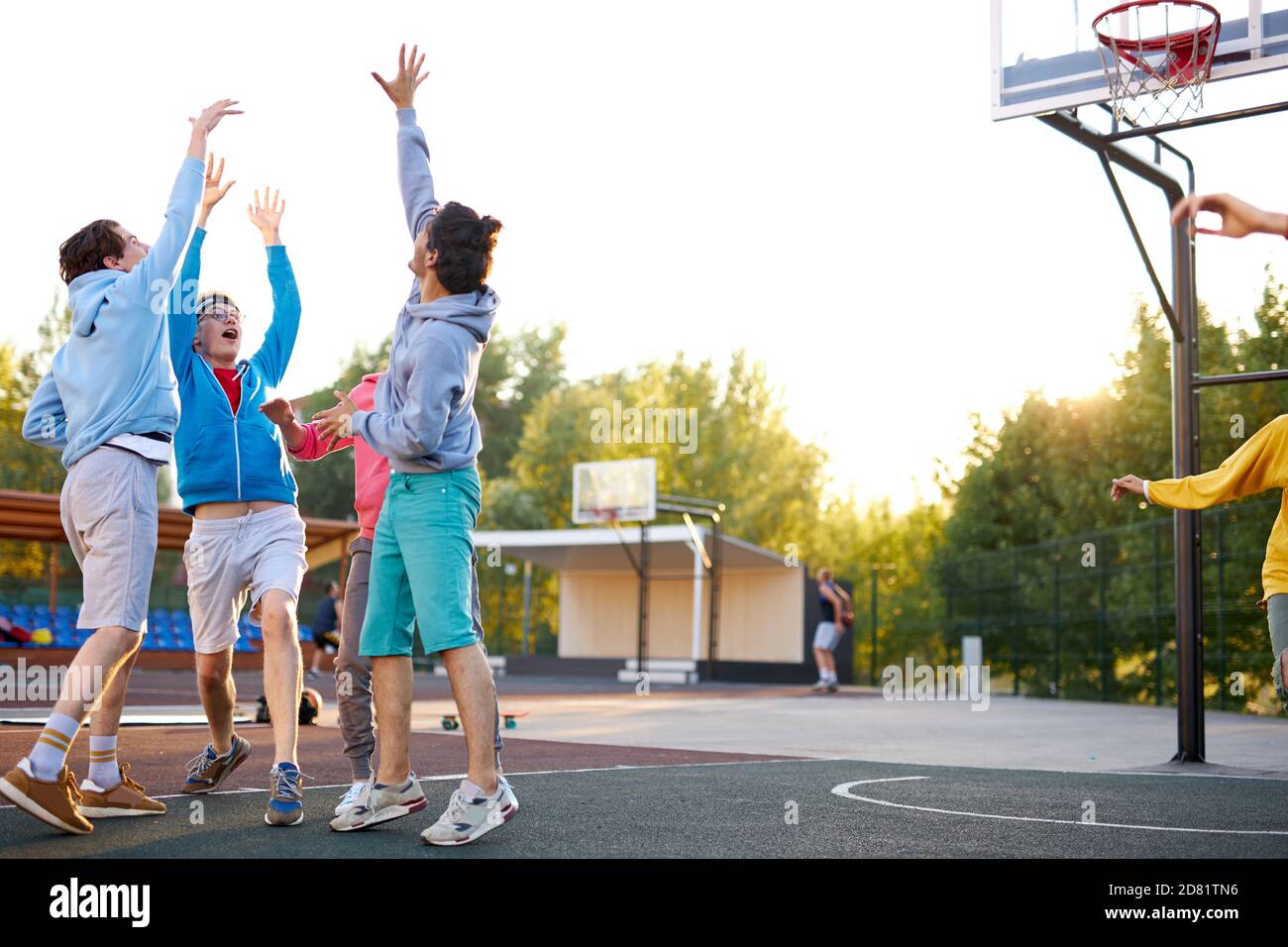 slam dunk. young caucasian basketball players, boys throwing ball into ...