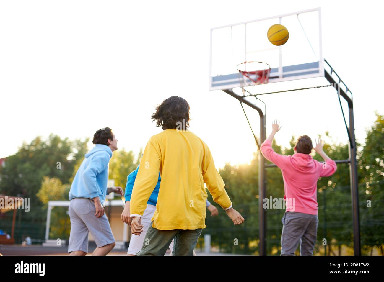 slam dunk. young caucasian basketball players, boys throwing ball into ...