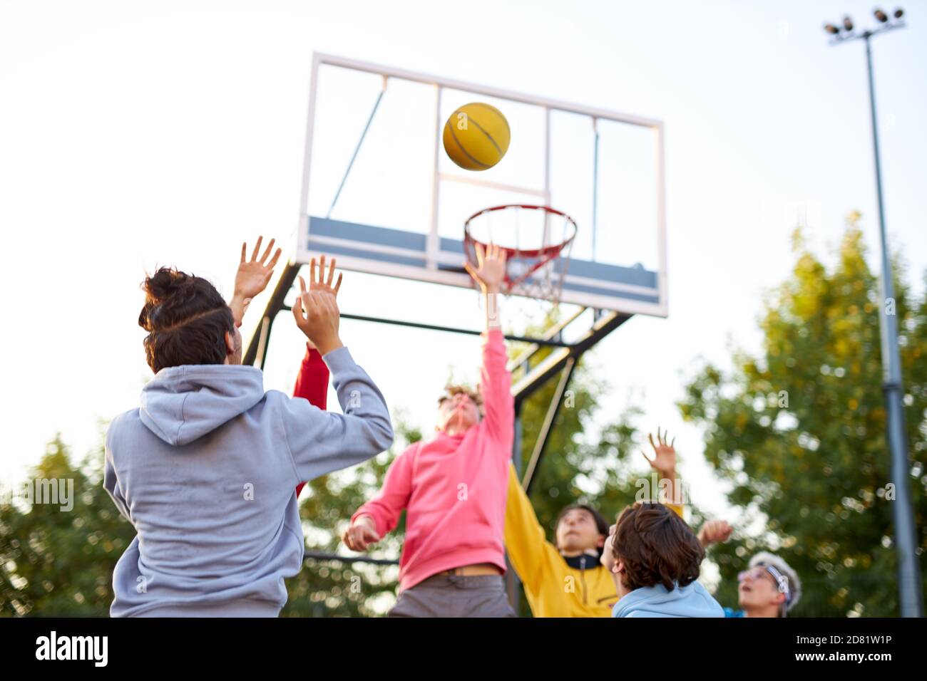 slam dunk. young caucasian basketball players, boys throwing ball into ...