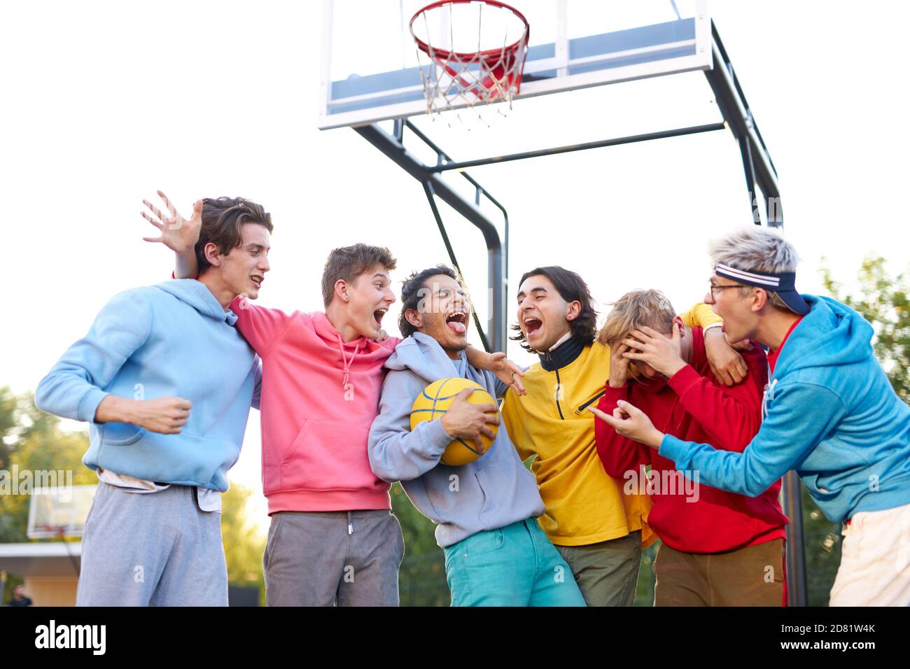 friendly team of young basketball players celebrate the winning in game ...