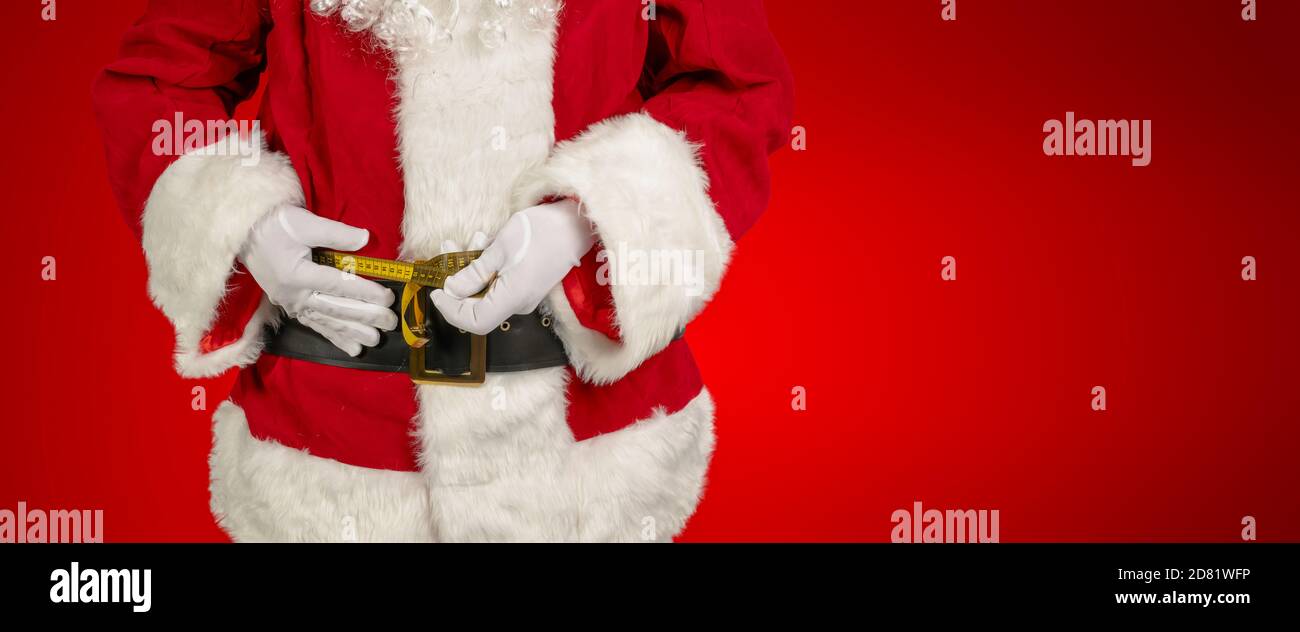 santa claus measures his stomach circumference with a tape measure ...