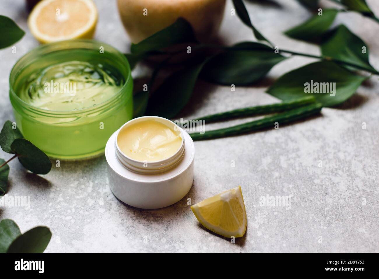 Yellow natural moisturizer in a white jar on a gray background. Cream ...