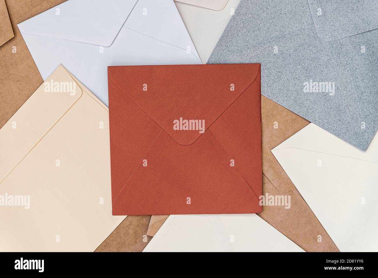 Red brown envelope, front view, against the background of other ...