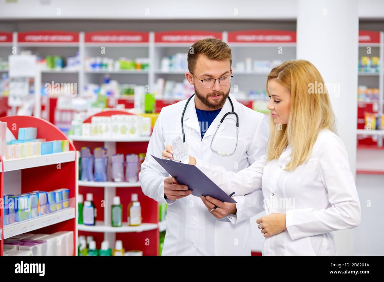 two apothecary man and woman talking, discussing medications ...