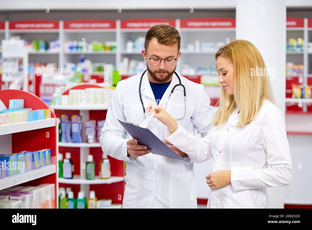 two apothecary man and woman talking, discussing medications ...