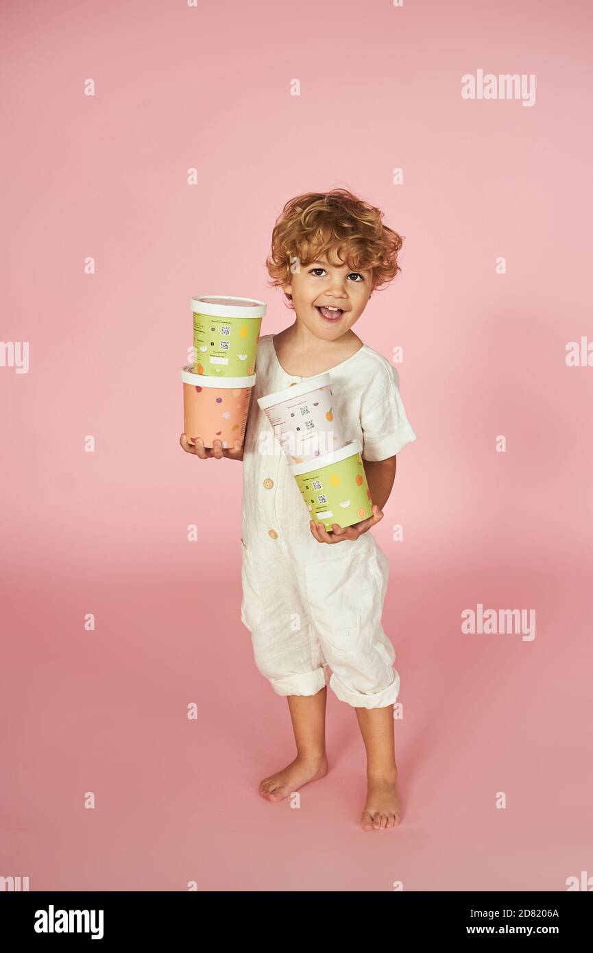 Red-haired boy with colored paper boxes Stock Photo - Alamy