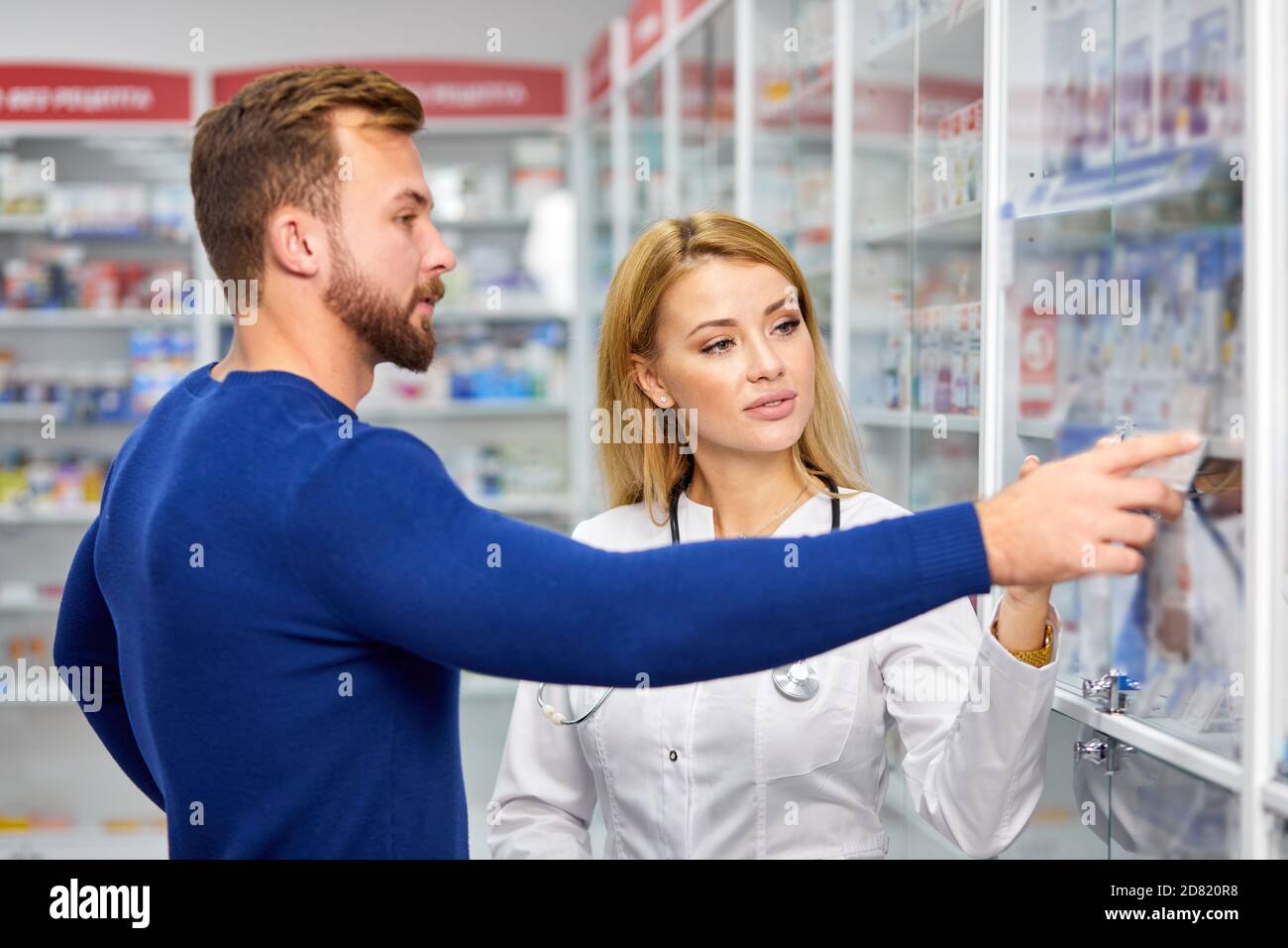 Male pharmacist talking woman hi-res stock photography and images - Alamy