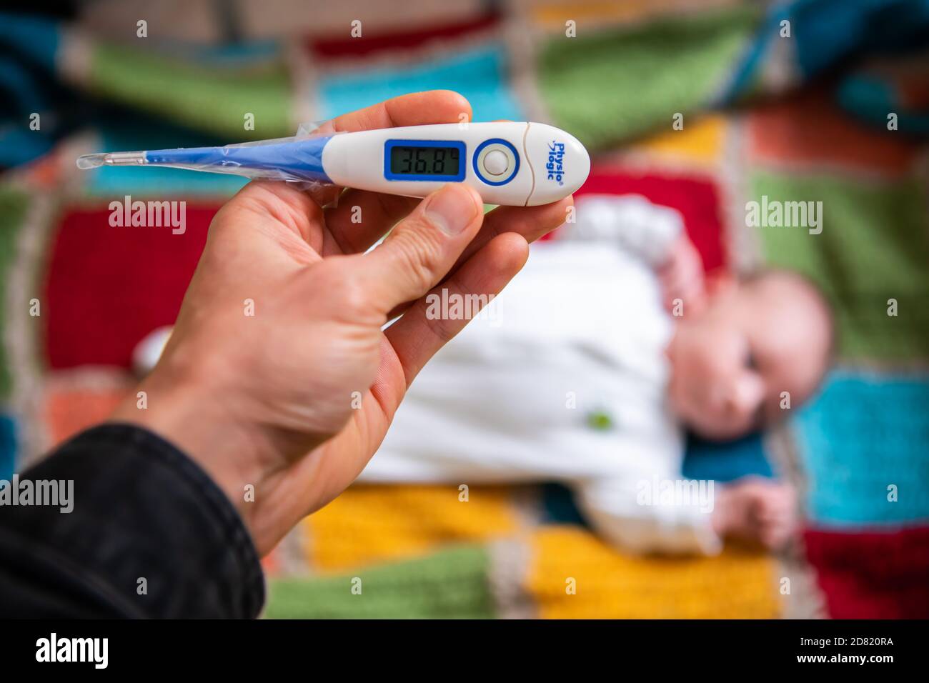 Selective focus of male hands holding digital thermometer checking ...