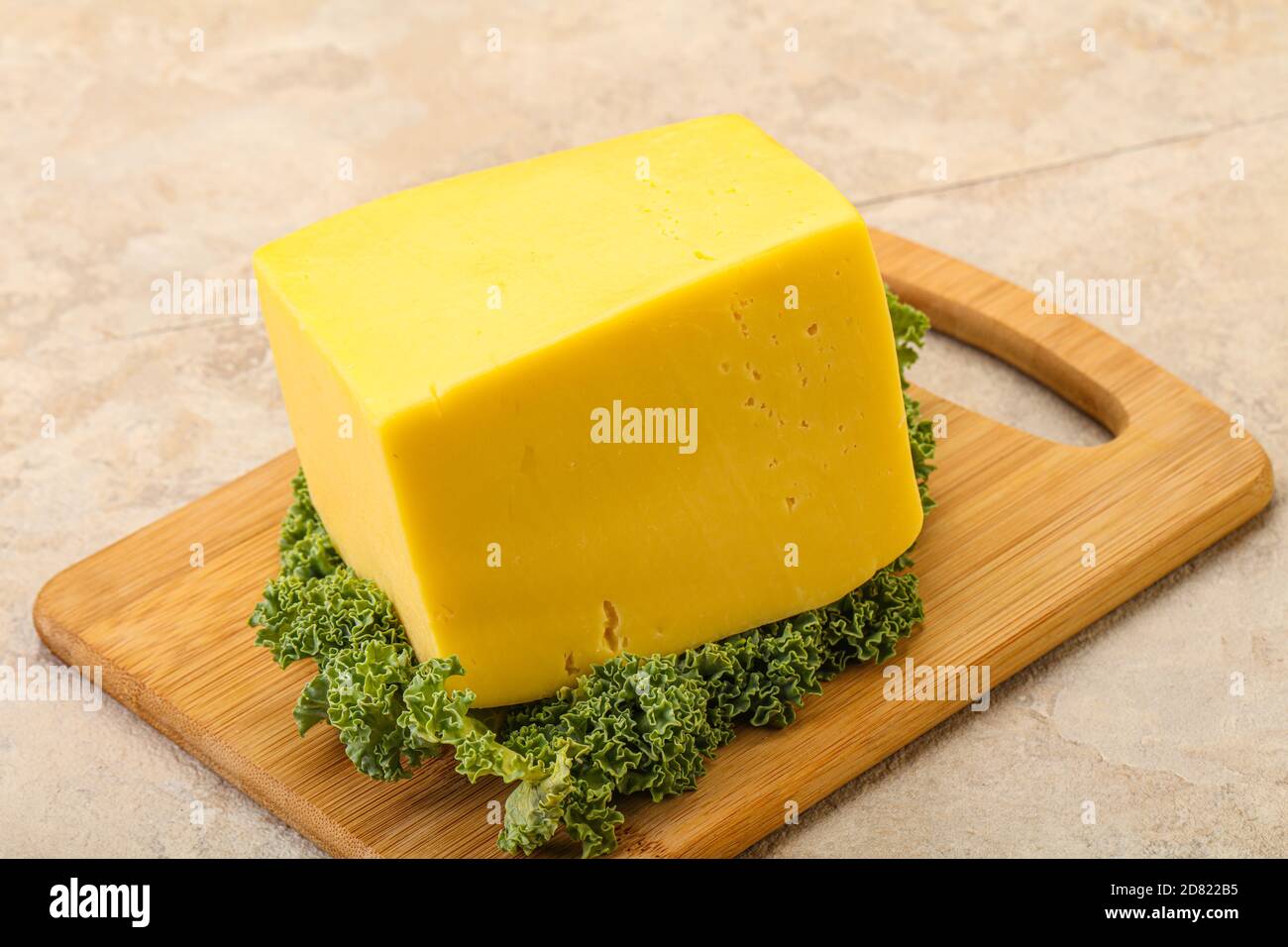 Yellow tilsiter cheese dairy product brick Stock Photo - Alamy