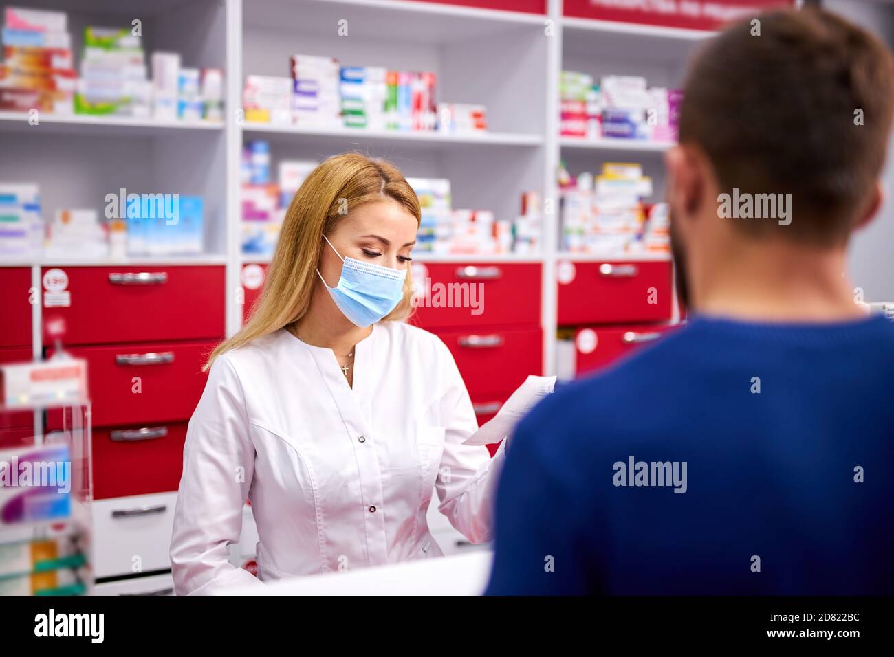 professional female pharmacist helping male customer choosing ...