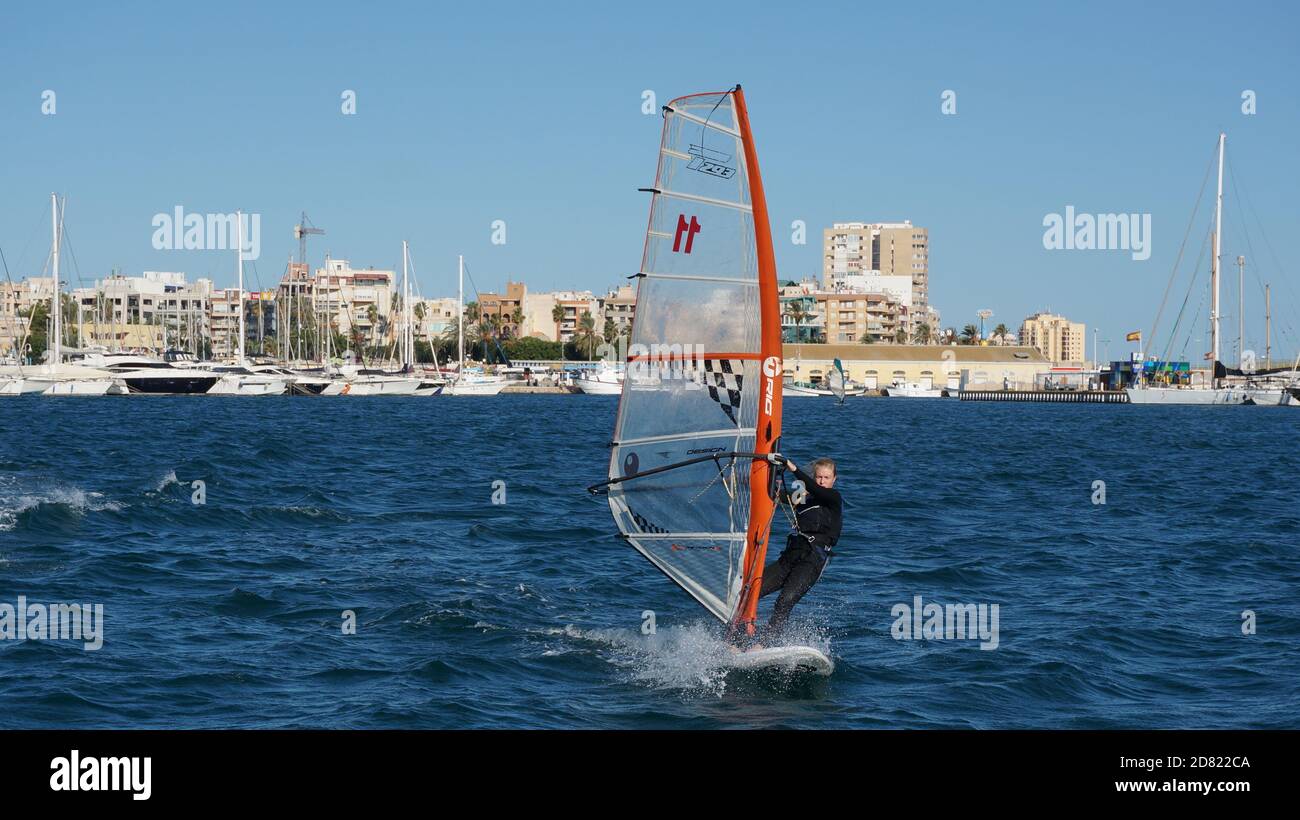 Alicante, Spain - October, 2020: Young people practicing windsurfing ...