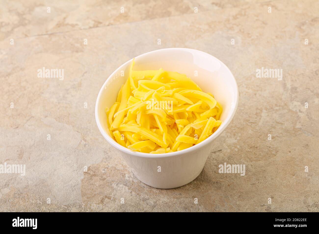 Shredded yellow cheese in the bowl for cooking Stock Photo - Alamy
