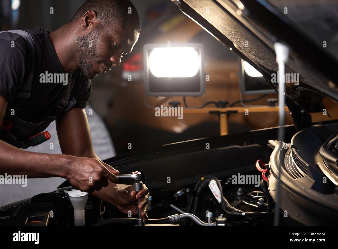 auto mechanic male use wrench and other tools for fixing a car engine ...