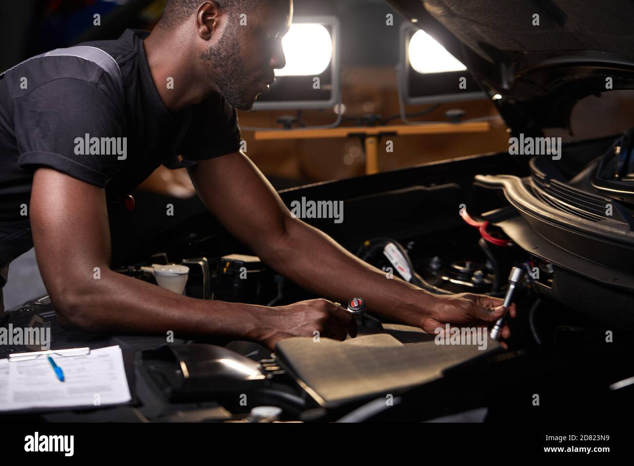 auto mechanic male use wrench and other tools for fixing a car engine ...