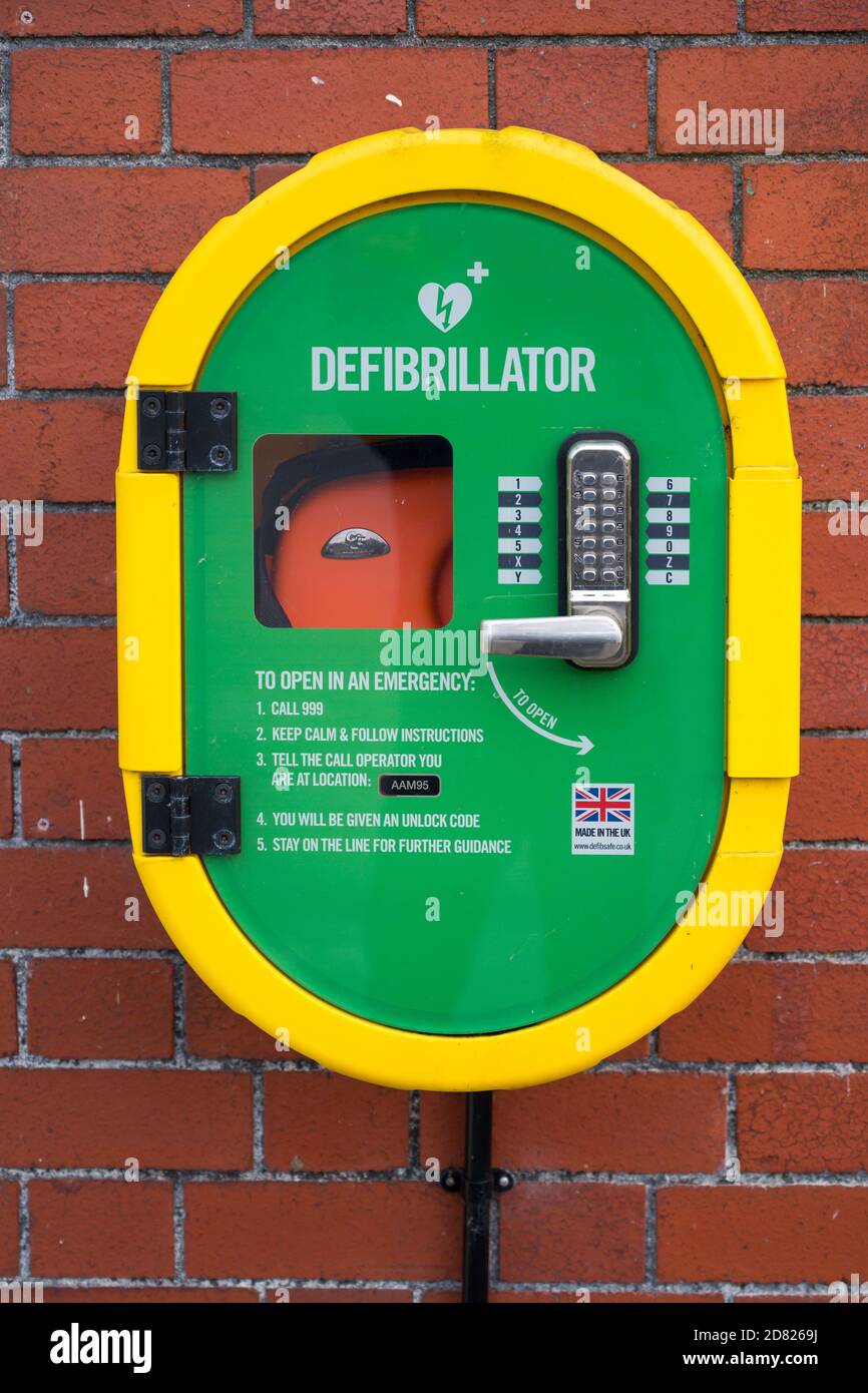 A defibrillator attached to a brick wall in the UK Stock Photo - Alamy