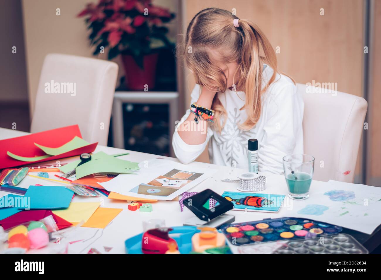 adorable blond girl making christmas card for friends and relatives ...