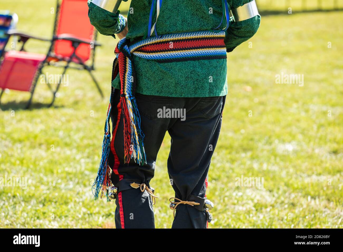 Selective focus of waist of unrecognized performer standing in colorful ...