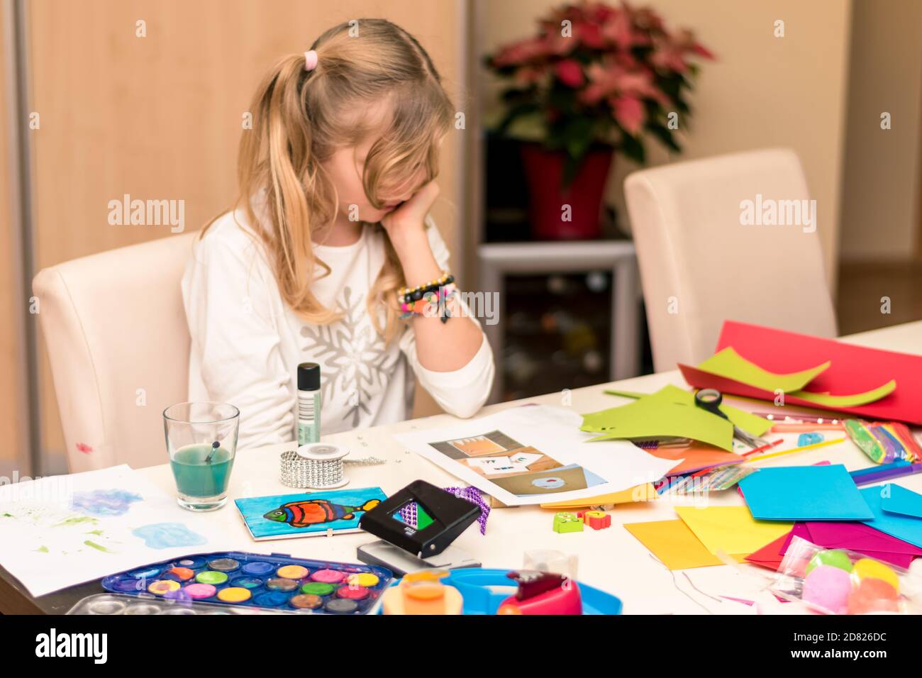 adorable blond girl making christmas card for friends and relatives ...