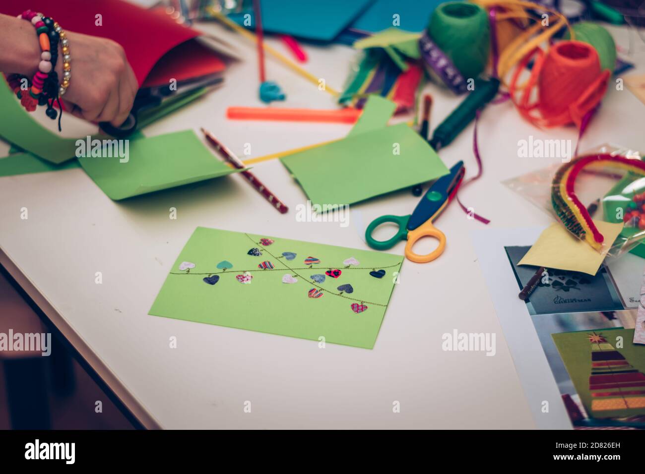 adorable blond girl making christmas card for friends and relatives ...