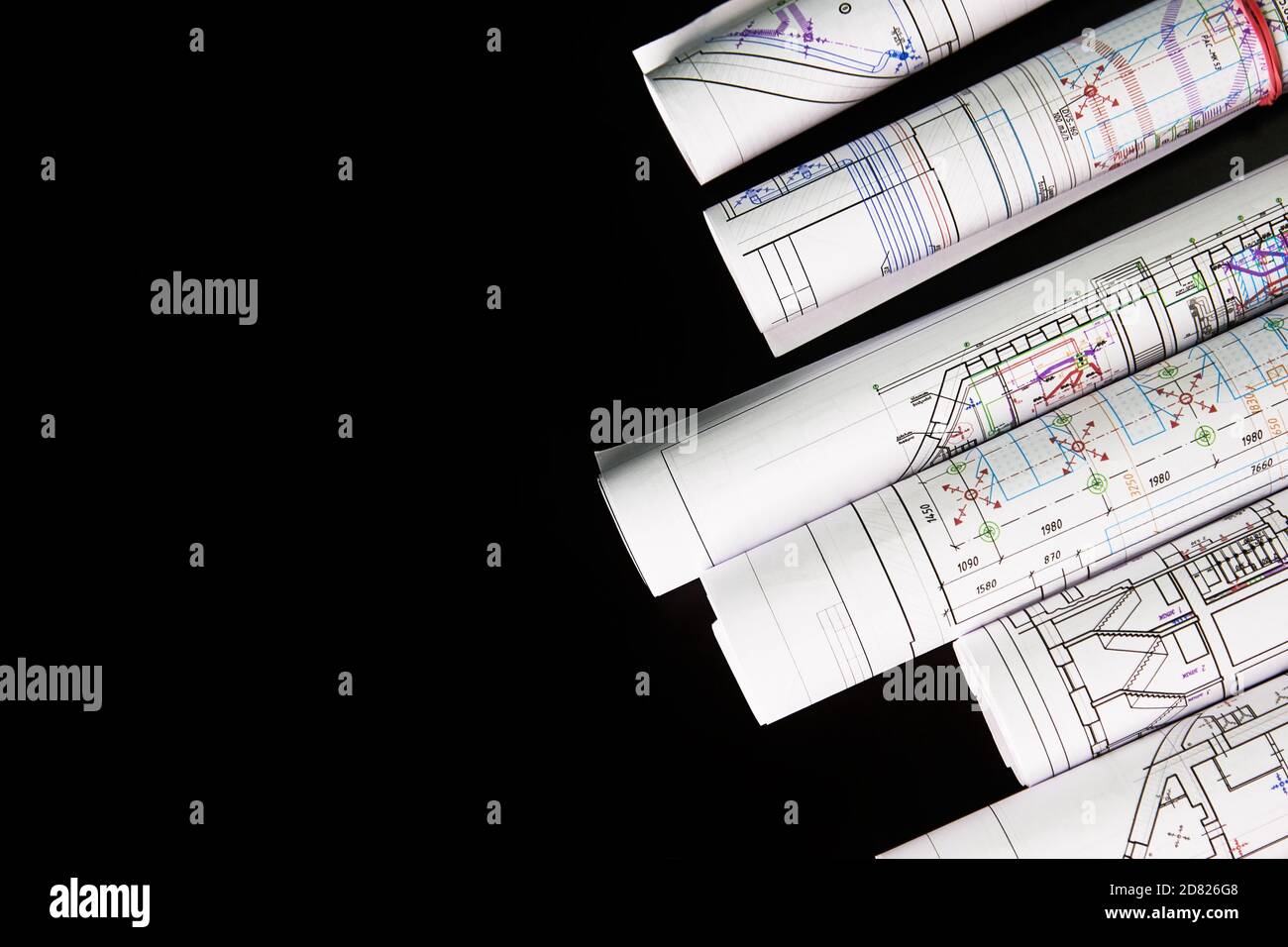 Architectural project, drawings on a dark background. Rolls of project ...