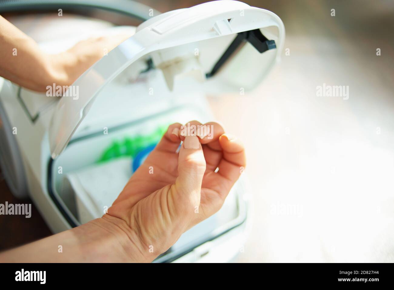 Closeup on woman in the house in sunny day checking nails after ...
