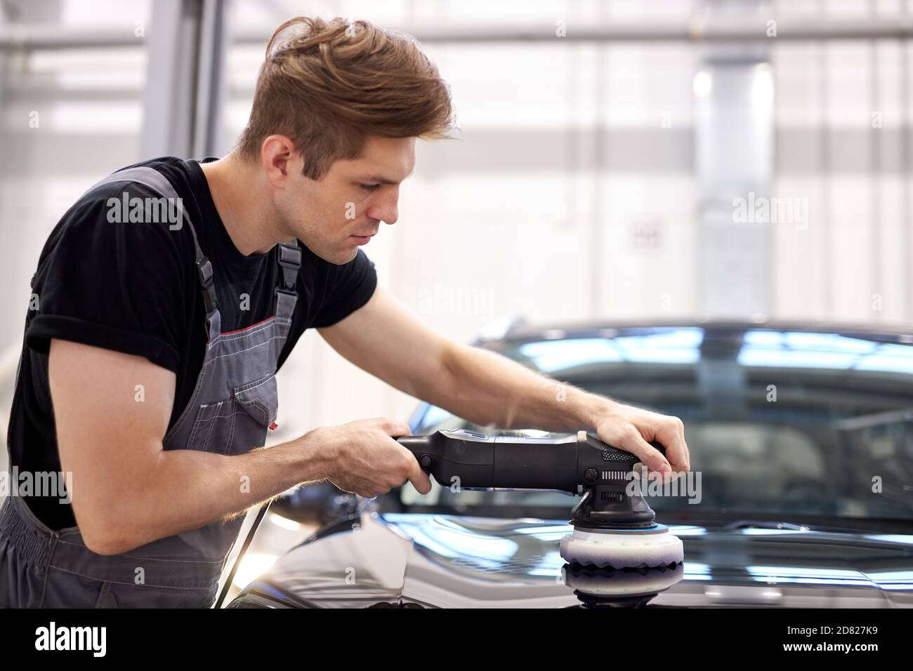 car detailing and polishing concept. young professional car service ...