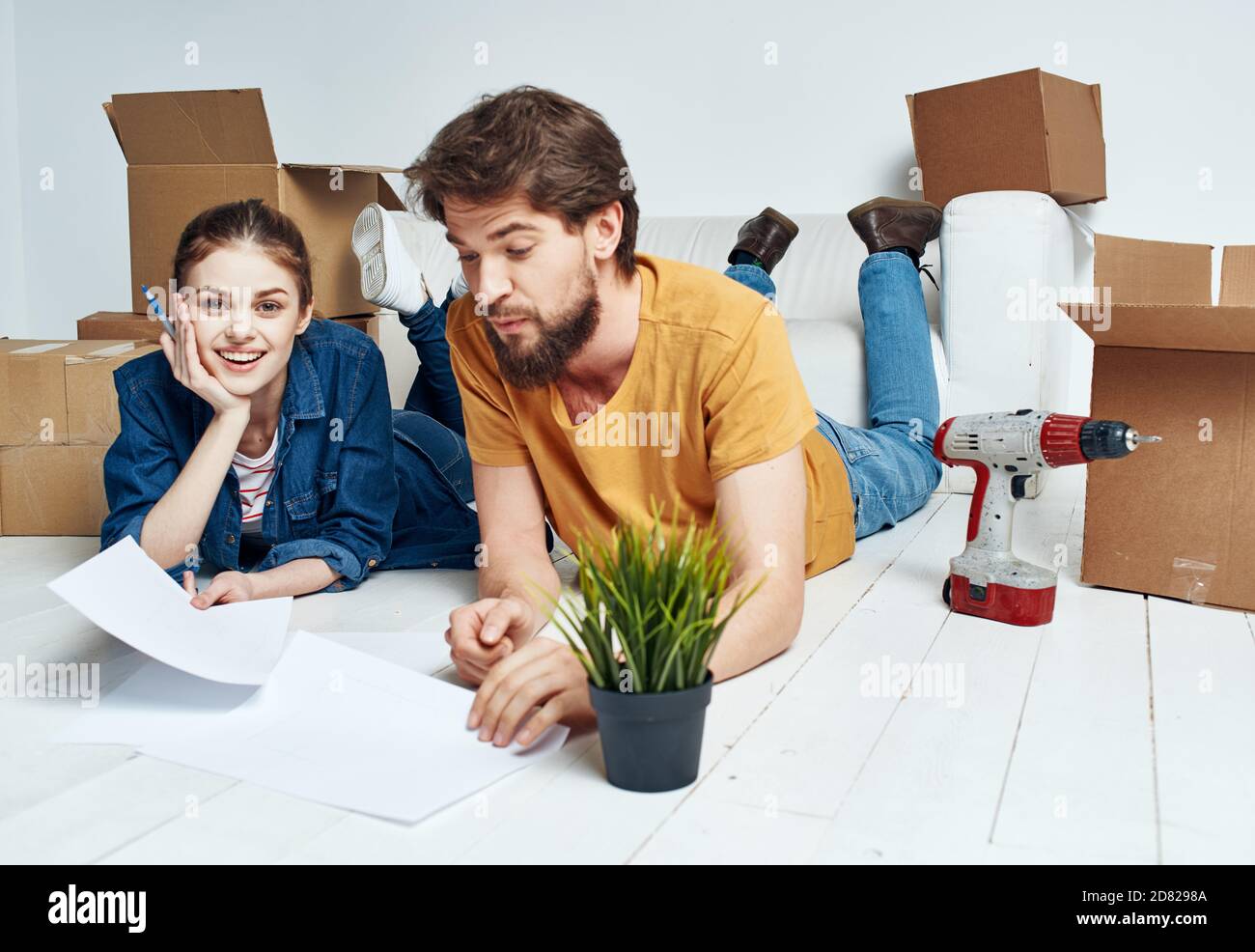 man and woman on the floor with boxes planning moving to apartment ...