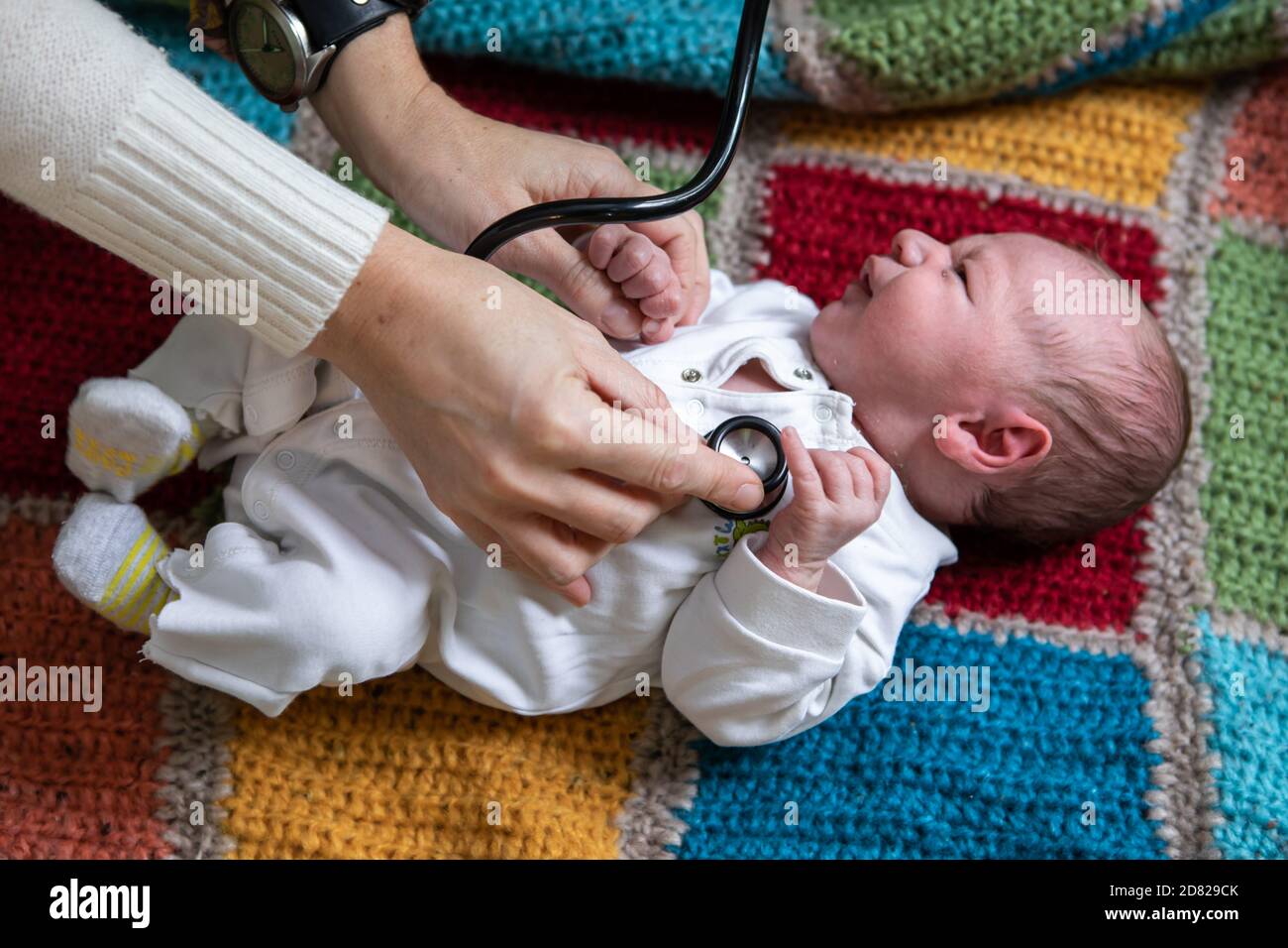 Doctor holding newborn hi-res stock photography and images - Alamy