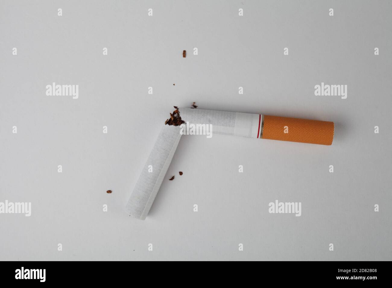 broken cigarette on white background, top view Stock Photo - Alamy