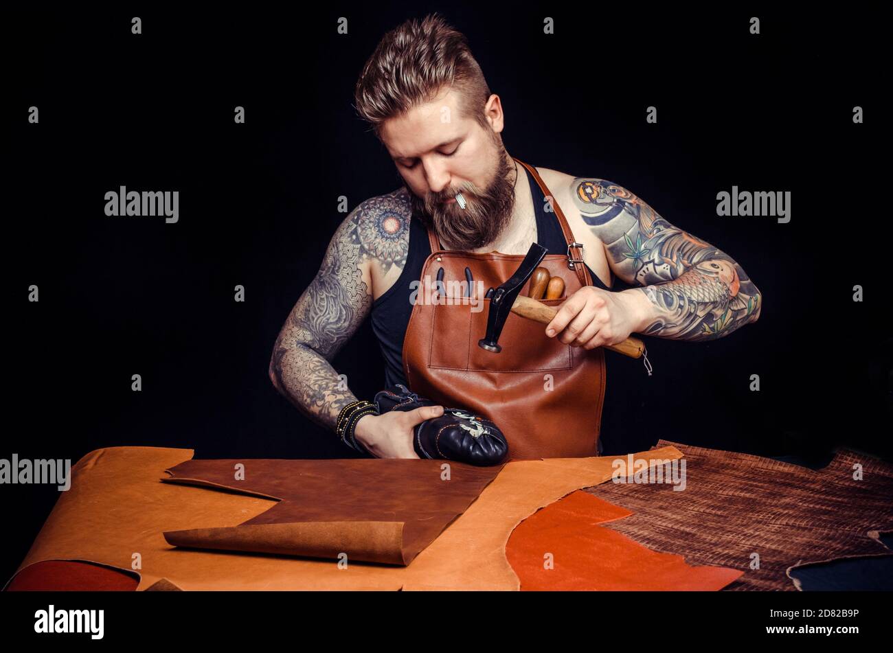Tanner of leather making quality products at the desk Stock Photo - Alamy