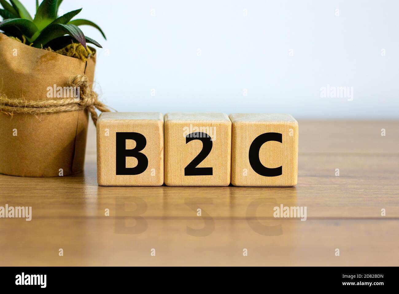 Concept word 'B2C - busines to customer' on cubes on a beautiful wooden ...