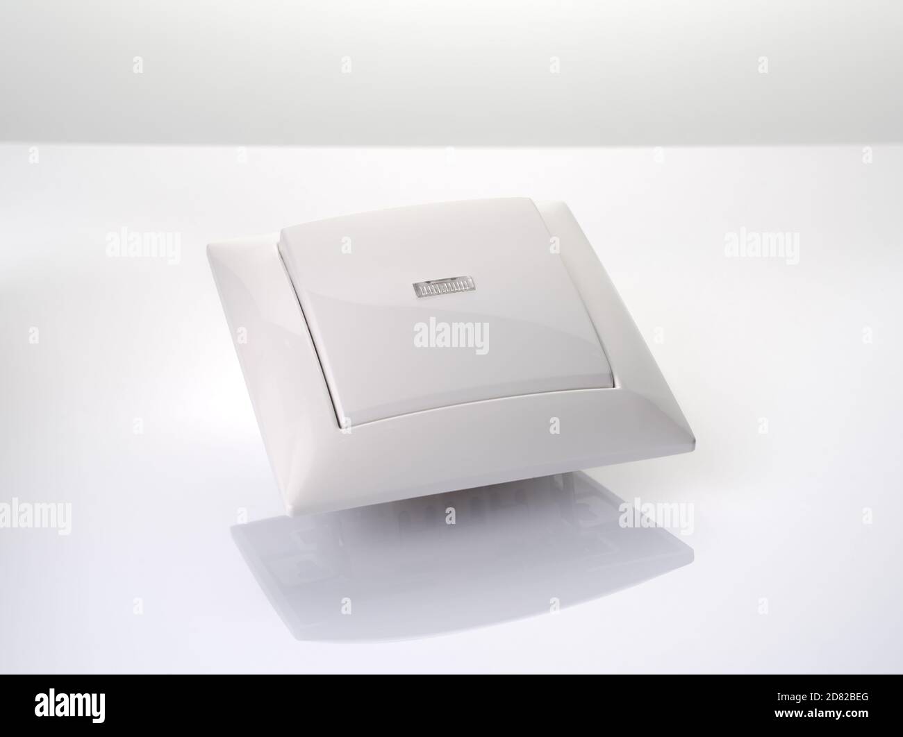 White glossy light regulator on a light background Stock Photo - Alamy