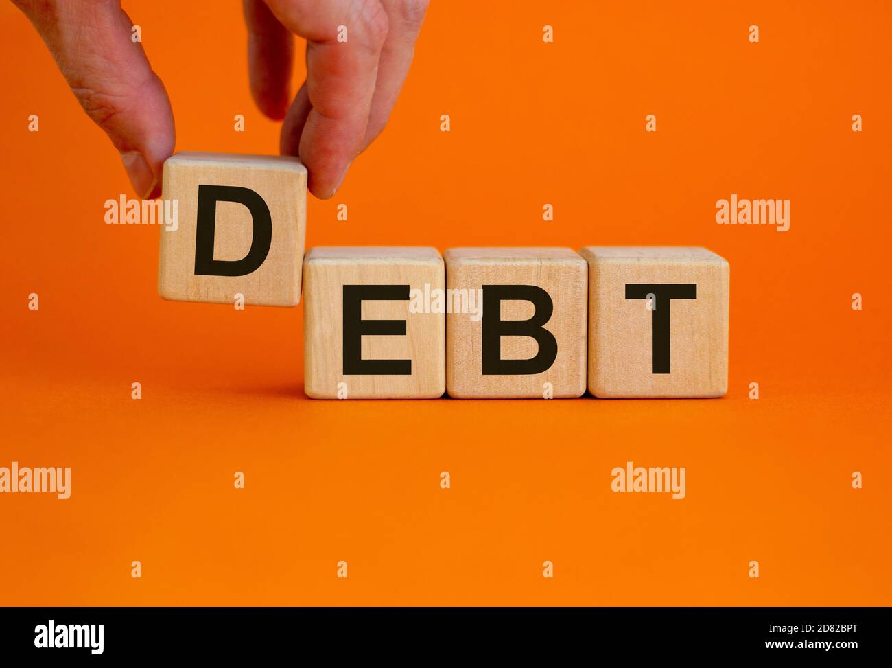 'DEBT' sign written on wood blocks. Business concept. Copy space ...