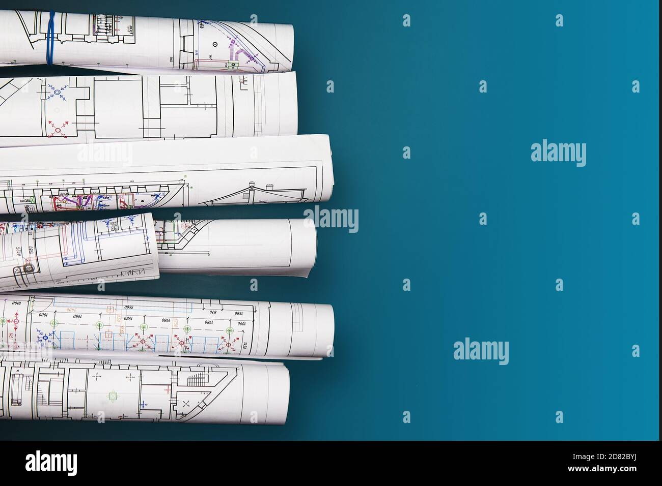 Architectural project, drawings on a dark background. Rolls of project ...