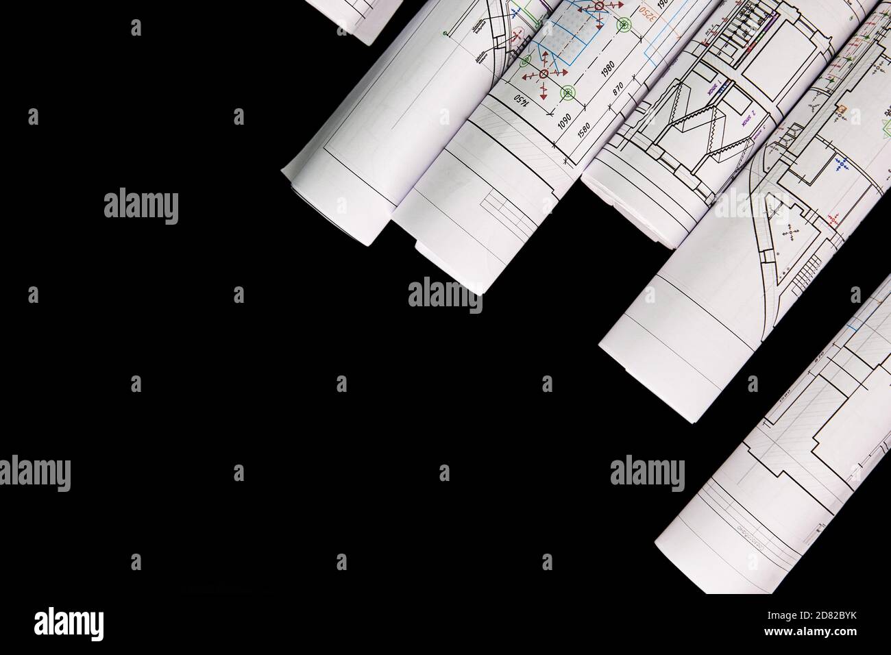 Architectural project, drawings on a dark background. Rolls of project ...