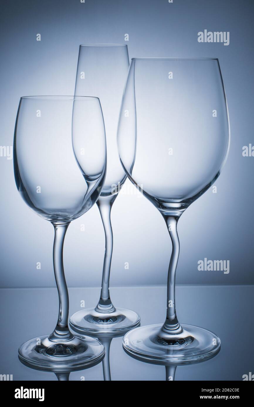Wine glasses with reflection on a colored background Stock Photo - Alamy