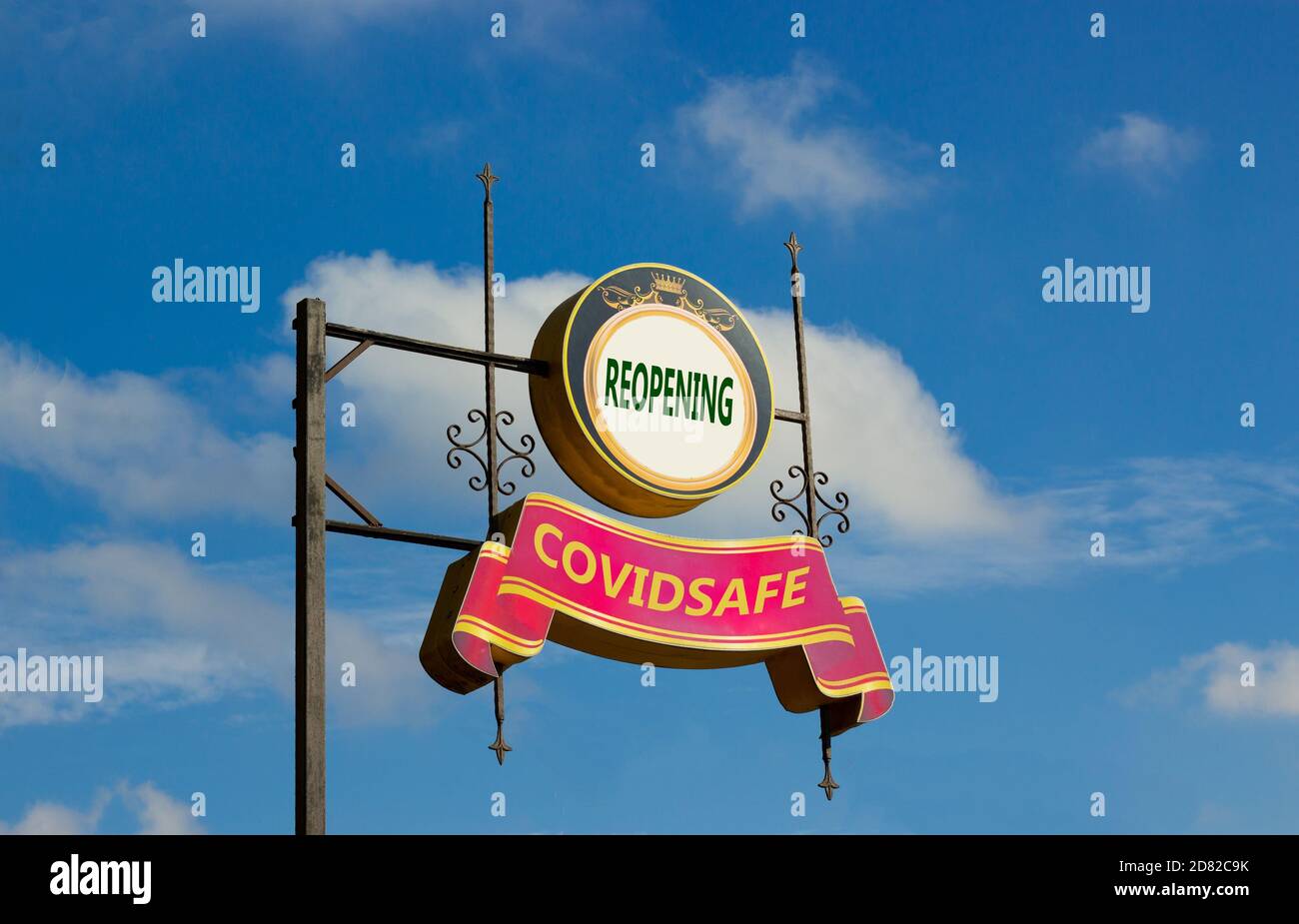 Street signs with text 'reopening, covidsafe' on metal pole. Blue sky ...