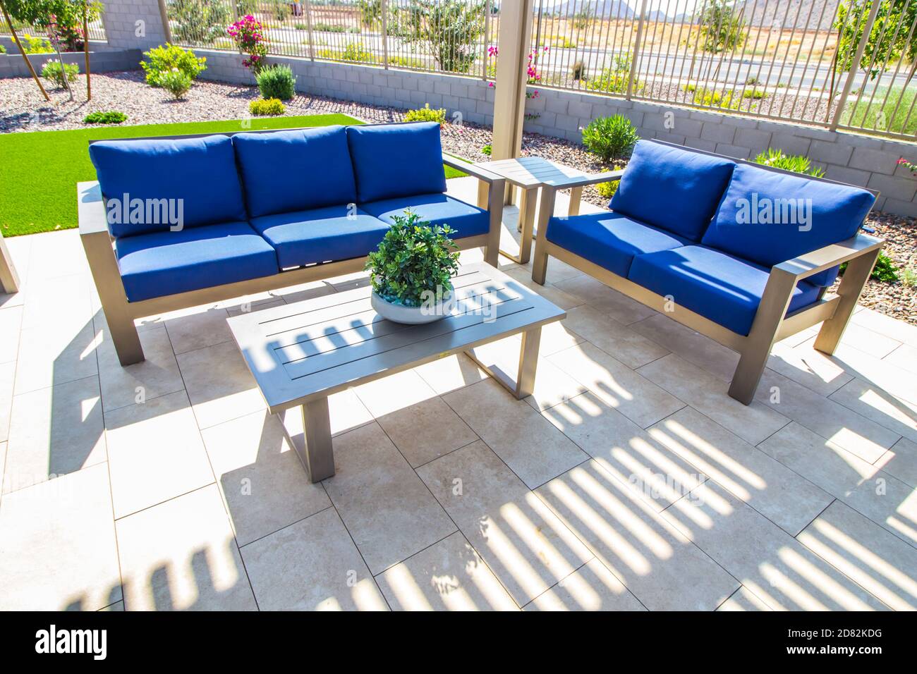 Rear Yard Patio Furniture Including Tables & Couches With Blue Cushions ...