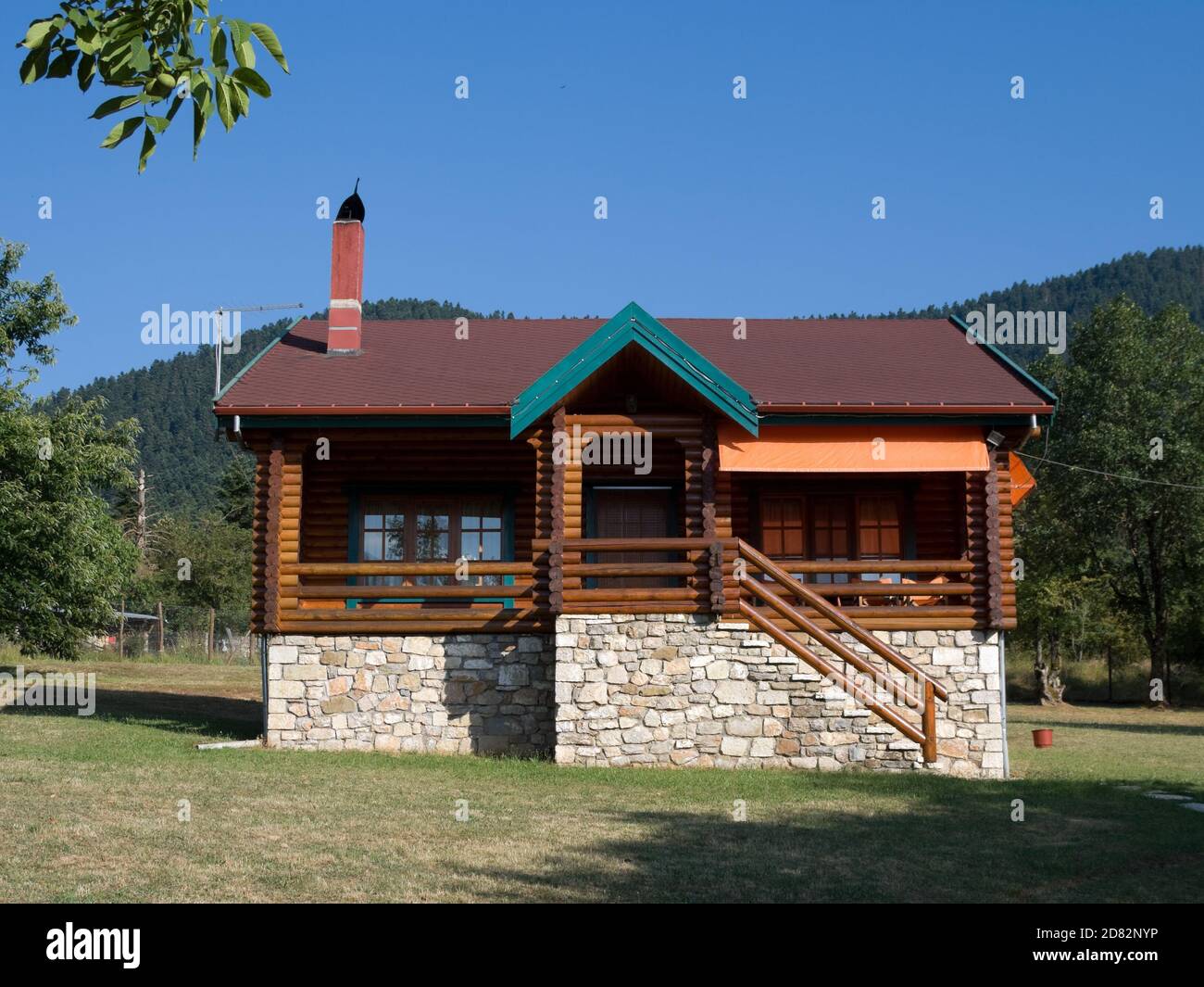 front view of log cabin in land considered the Swiss Alps of Greece ...