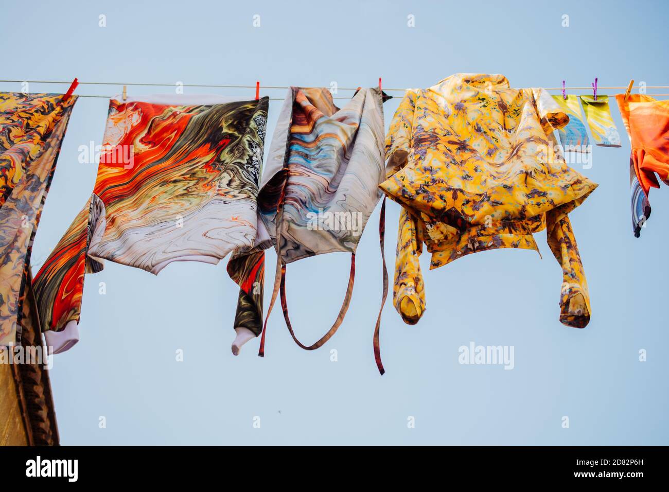 Clothes hanging from a clothes line rope in the street Stock Photo - Alamy