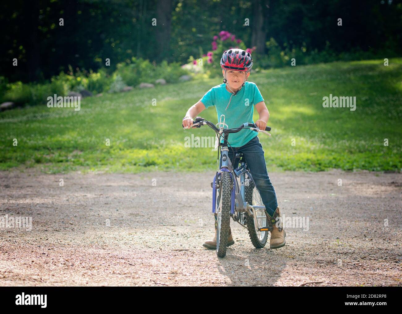 Young Boy on Bike in Driveway Stock Photo - Alamy