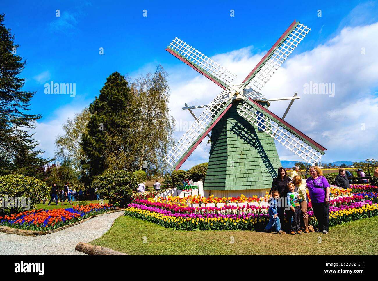 The family takes pictures in front of the windmill inside the ...