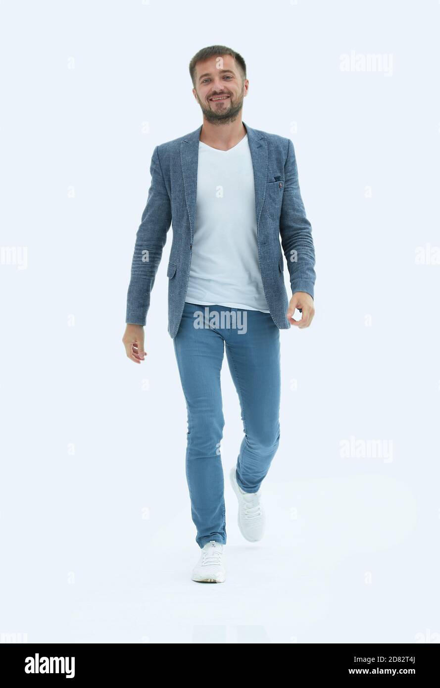 in full growth. confident young man striding forward Stock Photo - Alamy