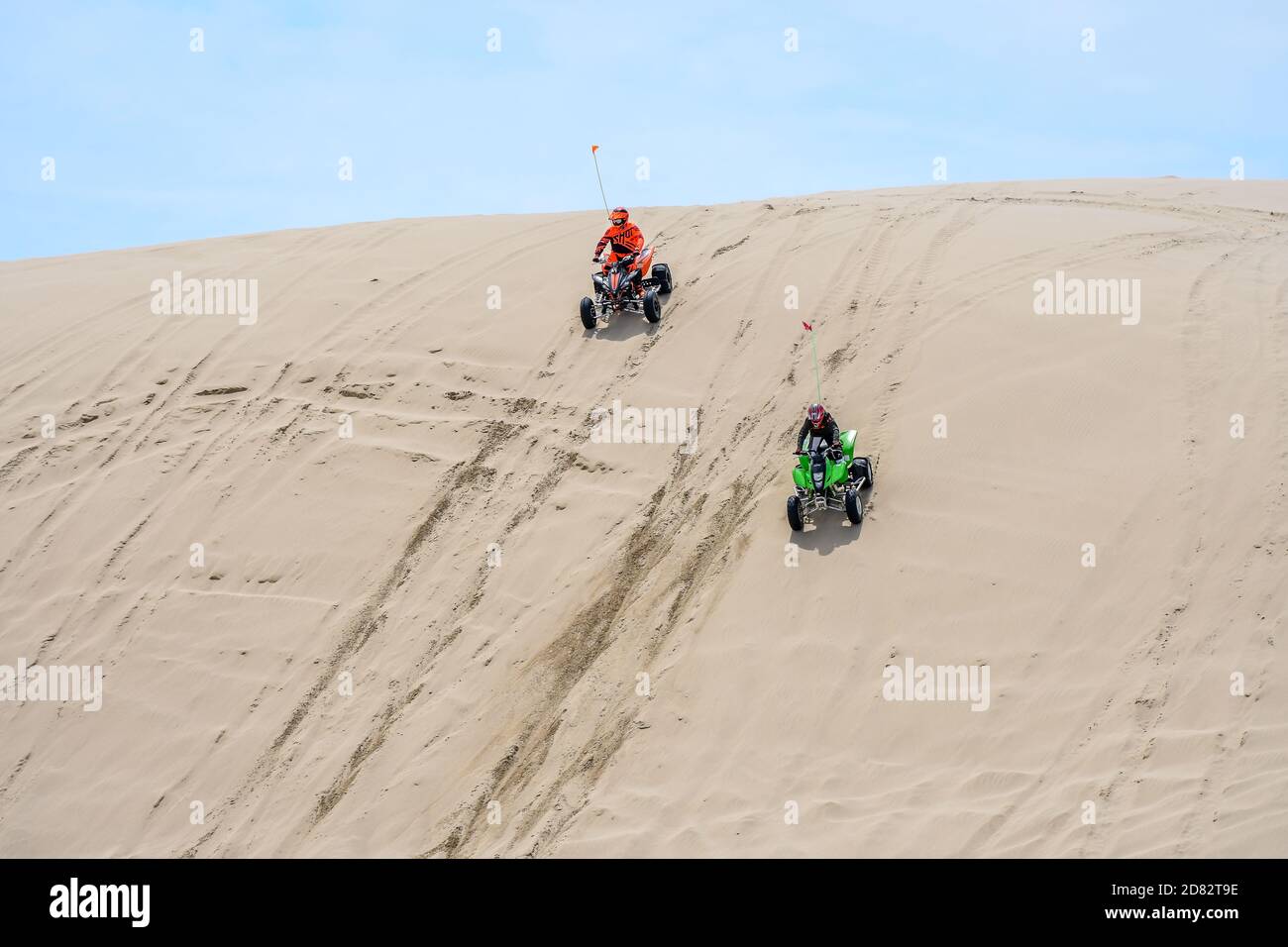 Off-road vehicle driving the Oregon Sand Dunes in late afternoon ...