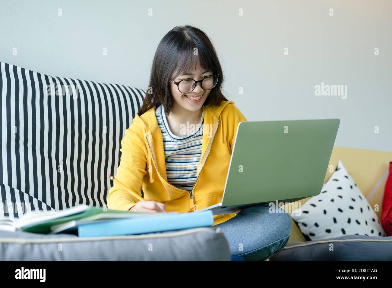 Young collage student using computer and mobile device studying online ...